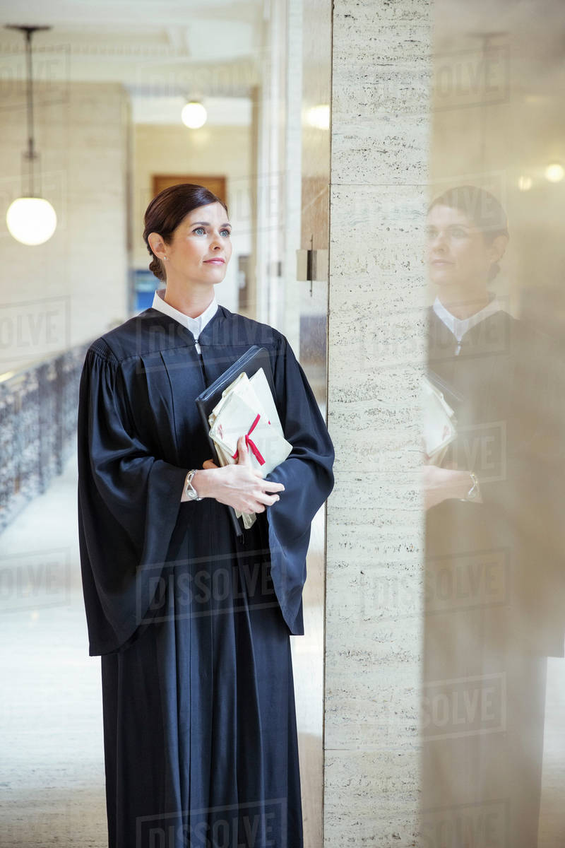 Judge looking out window in courthouse - Stock Photo - Dissolve