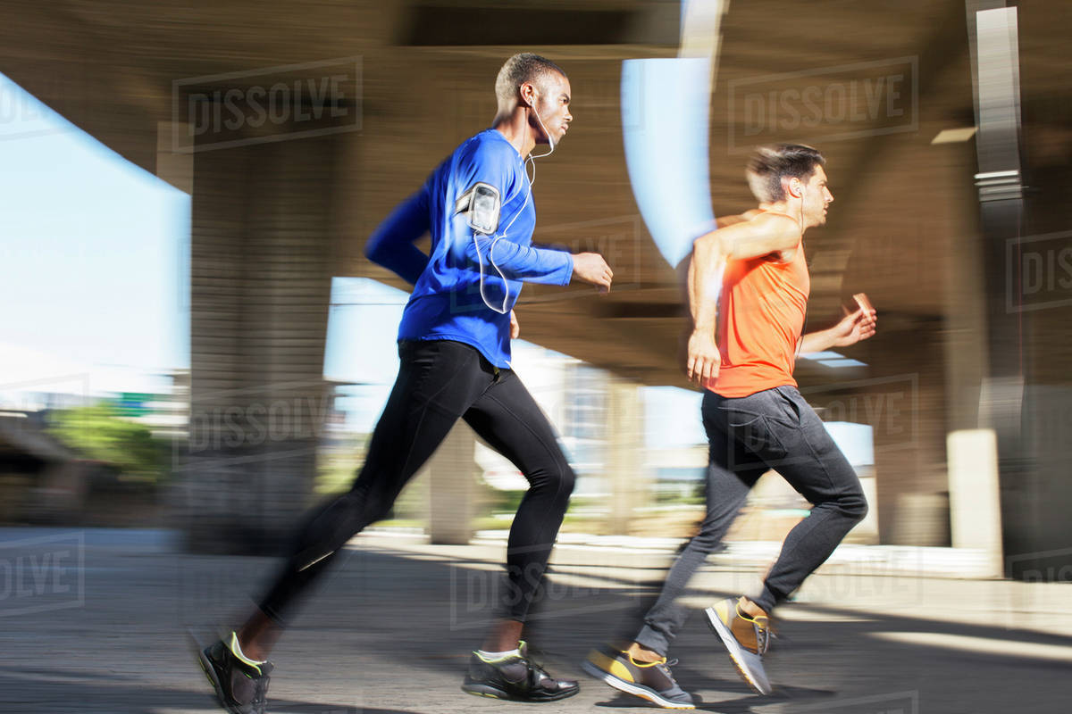 Men running through city streets together - Royalty-free Stock Photo ...