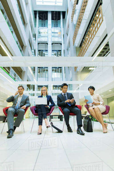 Business people sitting in office building - Stock Photo - Dissolve