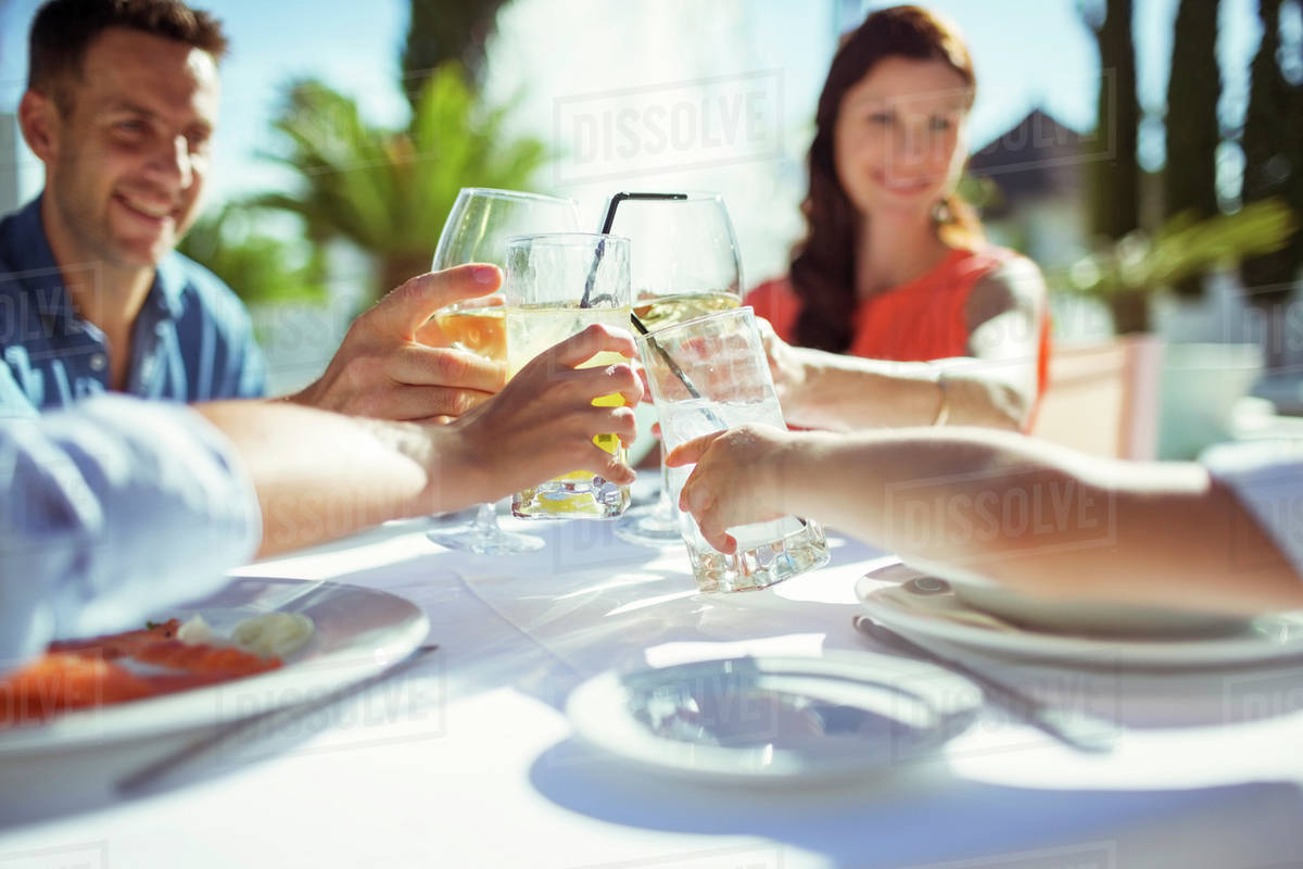 Friends raising toast at table outdoors - Royalty-free Stock Photo ...