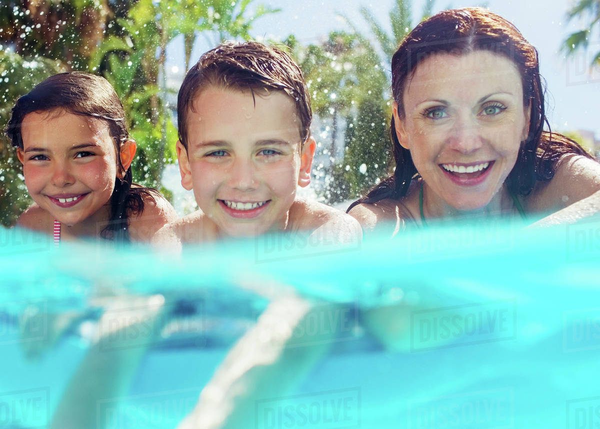 Portrait of mother with her two children in swimming pool - Royalty ...