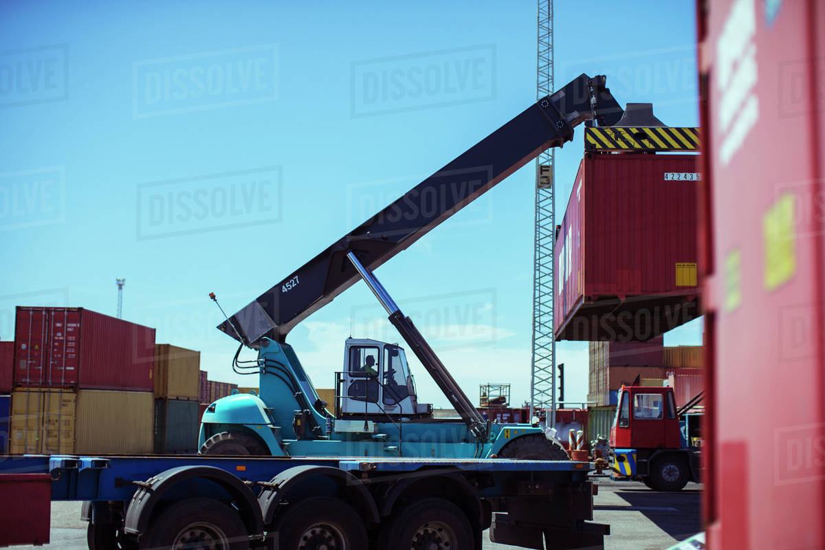 Crane lifting cargo container - Stock Photo - Dissolve