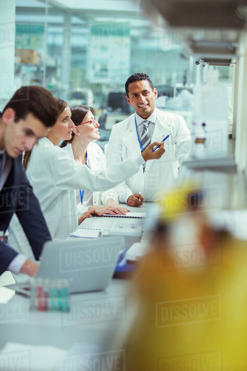 Scientists talking in laboratory - Stock Photo - Dissolve