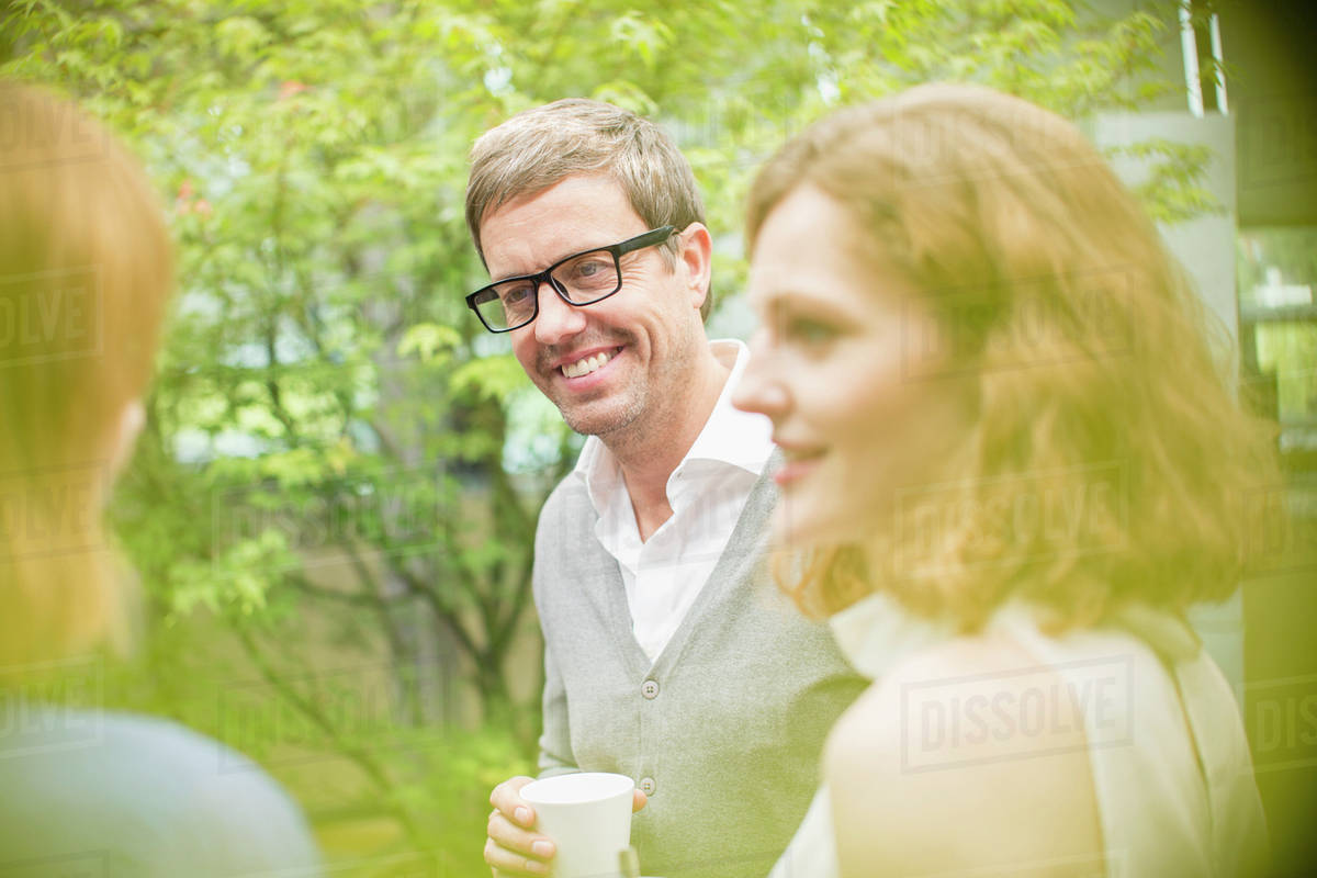 Business people talking outdoors - Royalty-free Stock Photo | Dissolve