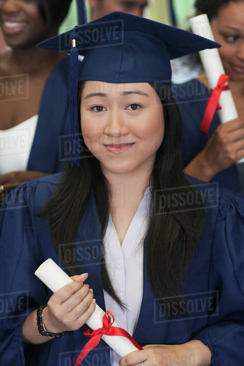 Female student smiling at camera and holding diploma - Royalty-free ...