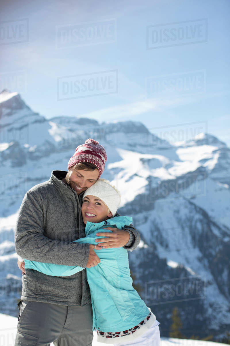 Couple hugging at mountains - Stock Photo - Dissolve