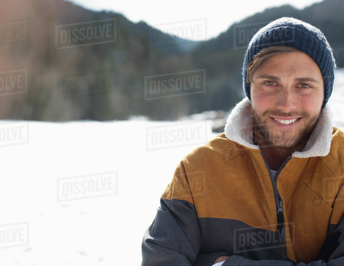 Portrait of smiling man in snow - Stock Photo - Dissolve