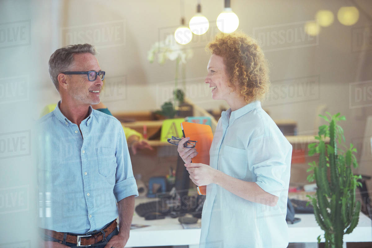 Three office workers talking at office - Royalty-free Stock Photo ...