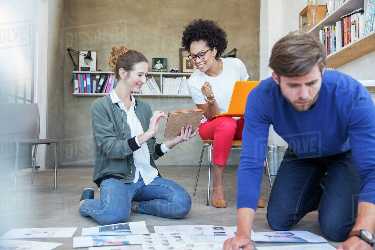 Three young people working together in studio - Stock Photo - Dissolve