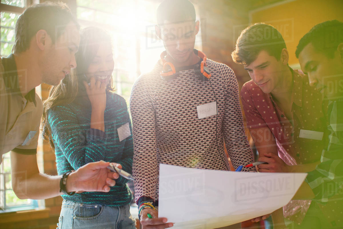 Creative business people reviewing proofs in meeting - Royalty-free ...