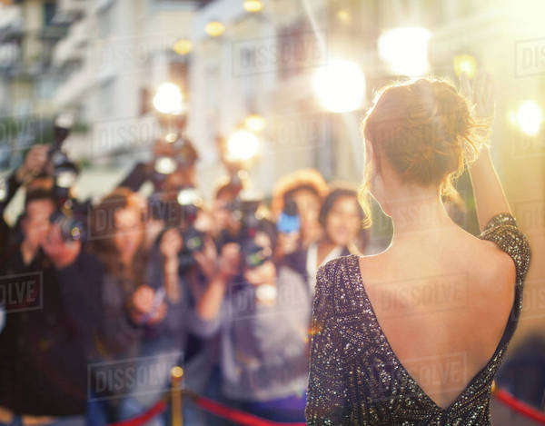 Celebrity waving at paparazzi photographers at event - Stock Photo ...