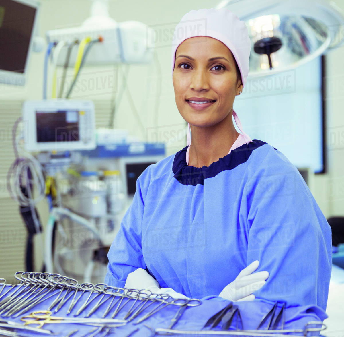 Portrait of confident surgeon near surgical scissors in operating room ...