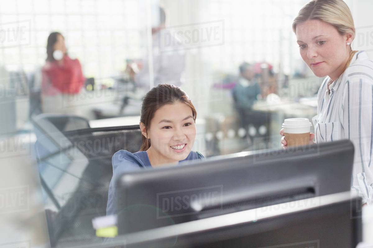 Businesswomen working at computer in office - Stock Photo - Dissolve