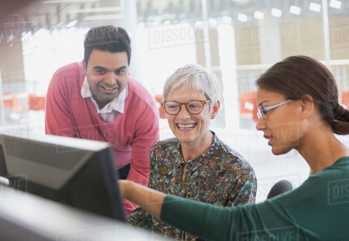 Business people working at computer in office - Stock Photo - Dissolve