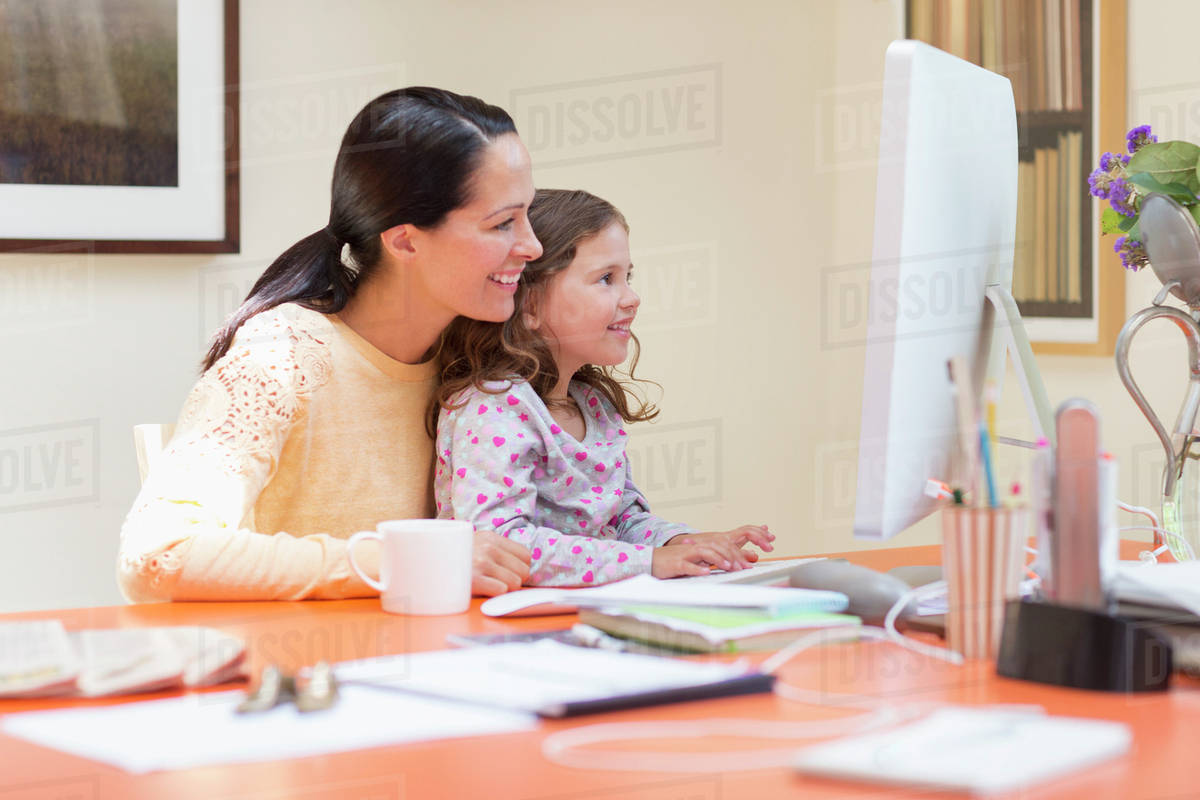 Mother and daughter using computer - Royalty-free Stock Photo | Dissolve