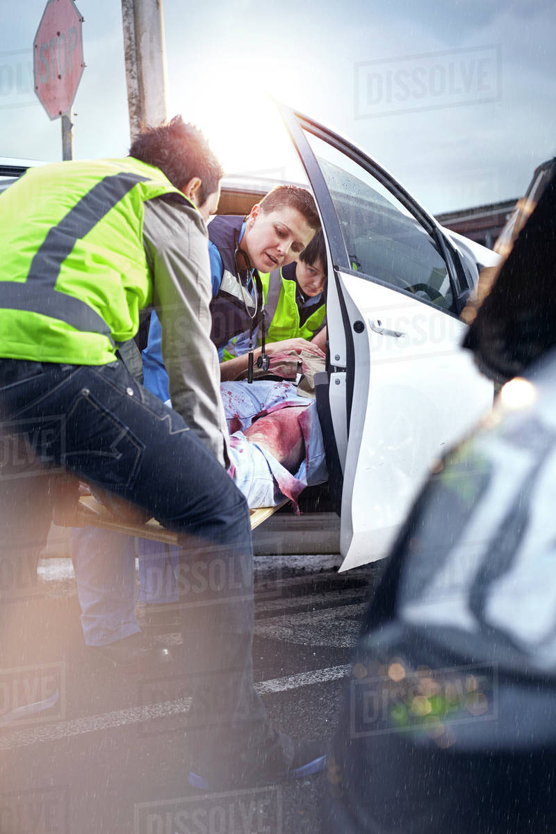 Rescue workers removing car accident victim from car - Royalty-free ...