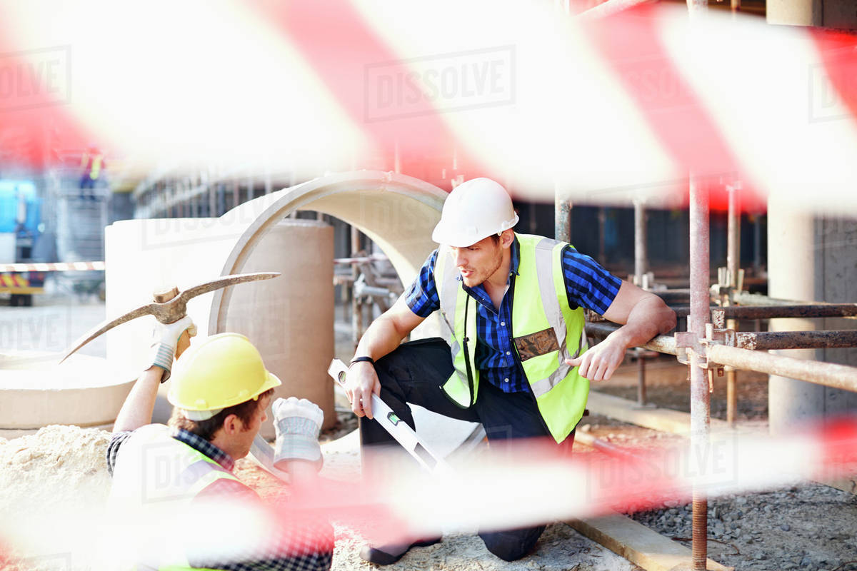 Construction workers talking at construction site - Royalty-free Stock ...
