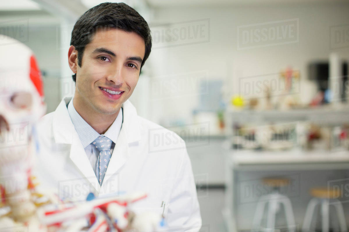 Portrait of smiling scientist with anatomical model n laboratory ...