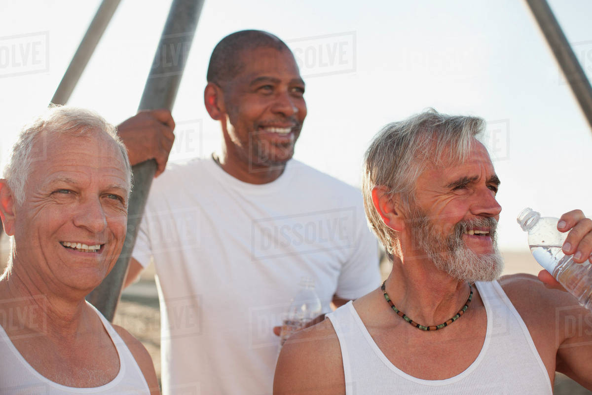 Older men relaxing outdoors together - Royalty-free Stock Photo | Dissolve