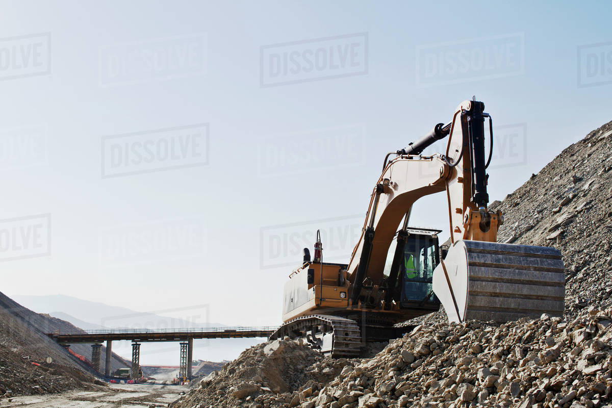 Digger working in quarry - Stock Photo - Dissolve
