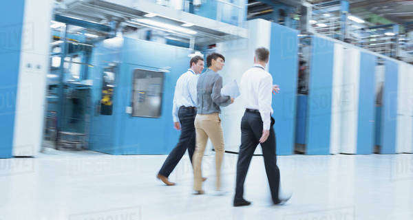 Workers walking in factory - Royalty-free Stock Photo | Dissolve