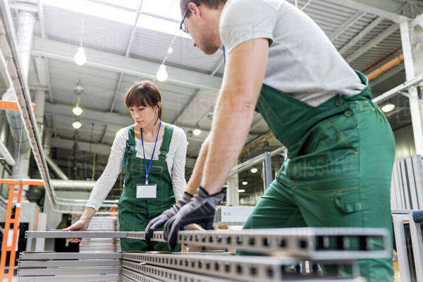 Workers moving steel parts in factory - Royalty-free Stock Photo | Dissolve