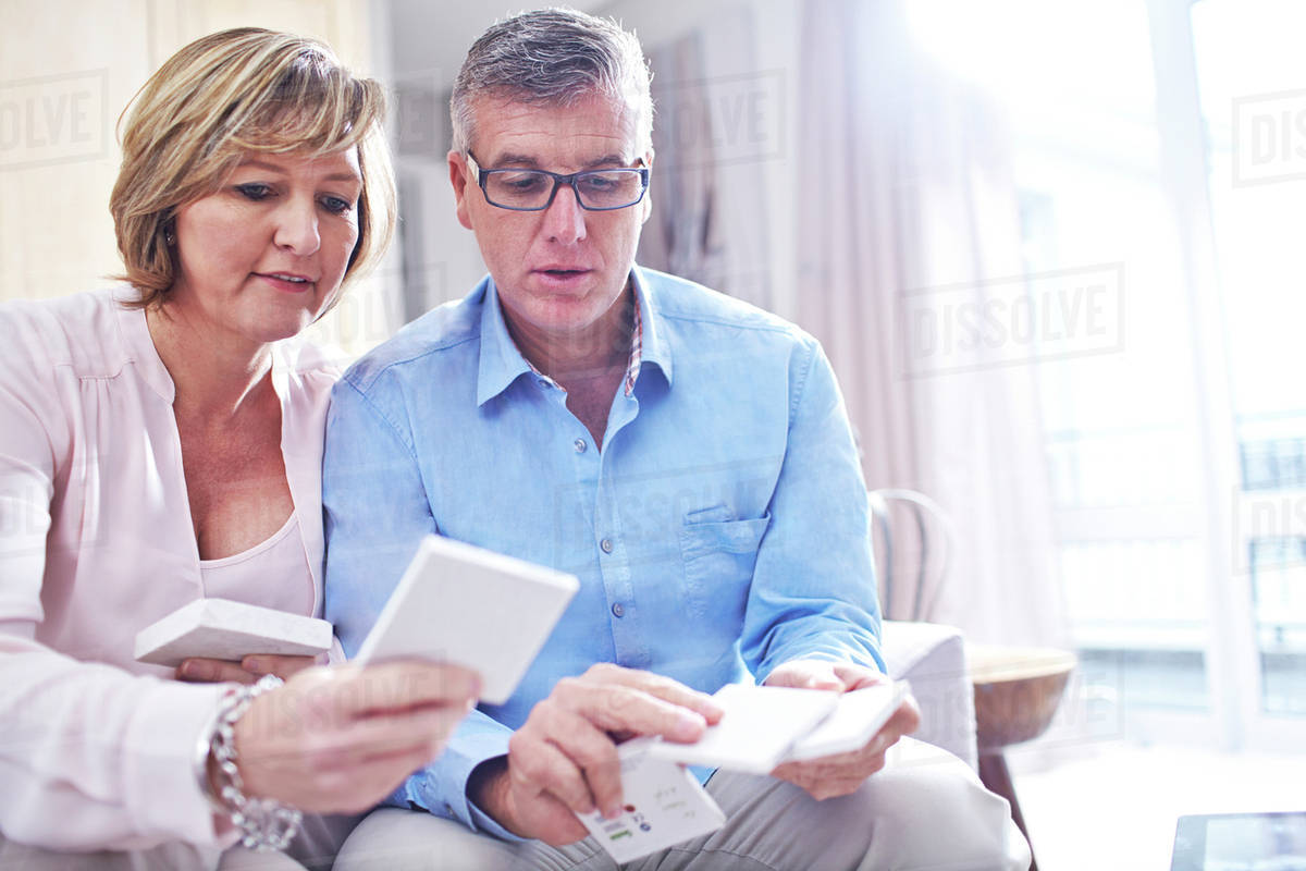 Couple browsing tile swatches - Stock Photo - Dissolve