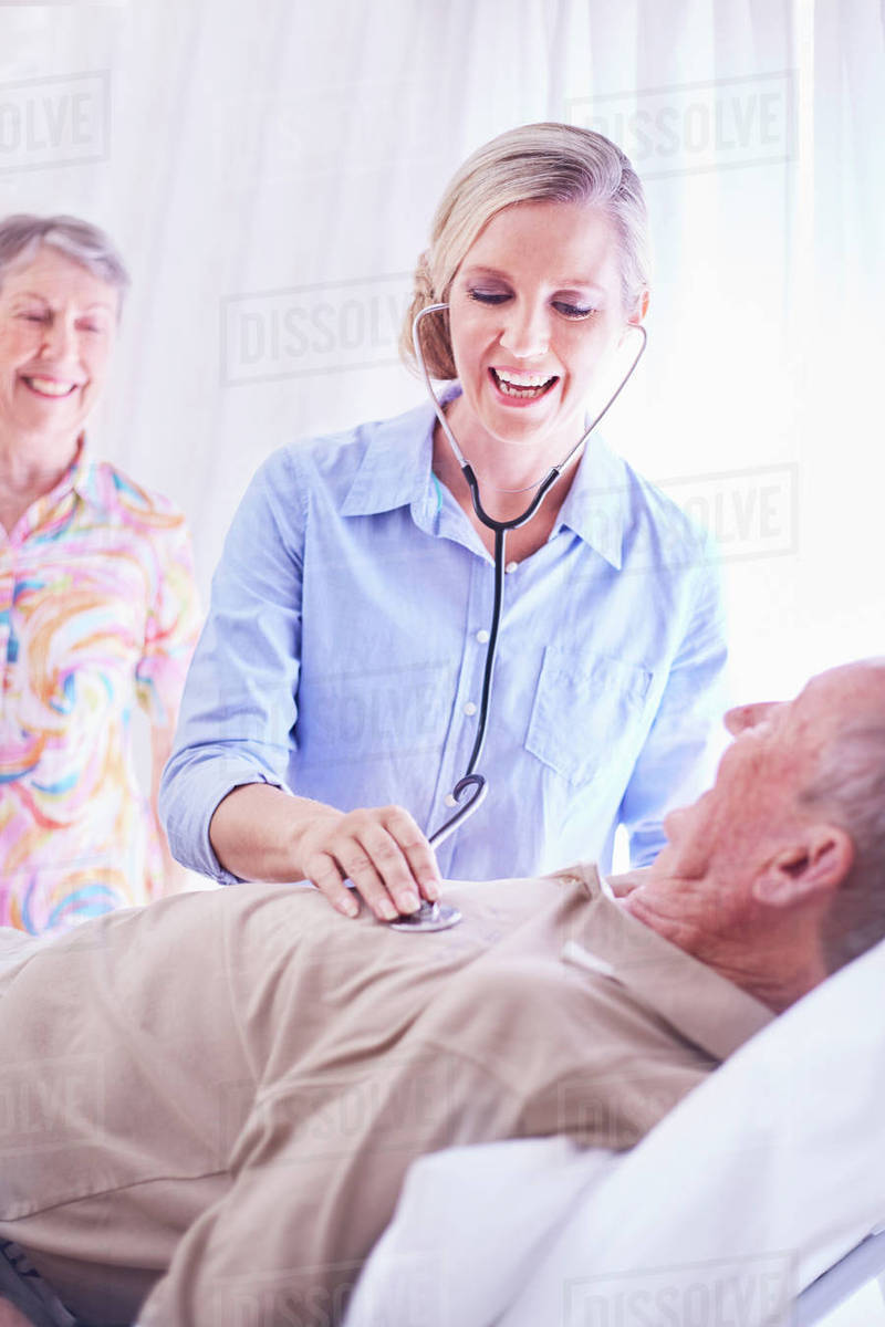 Doctor using stethoscope on senior man - Royalty-free Stock Photo ...