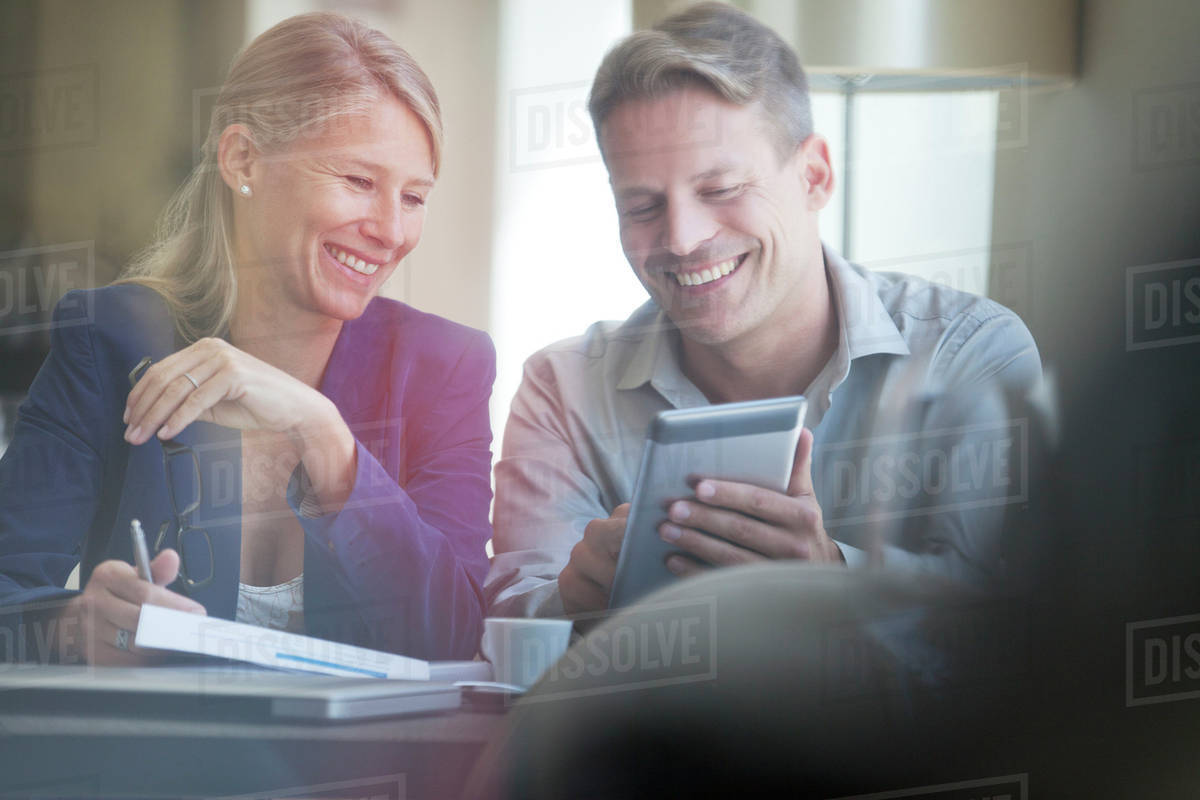 Business people using digital tablet - Stock Photo - Dissolve