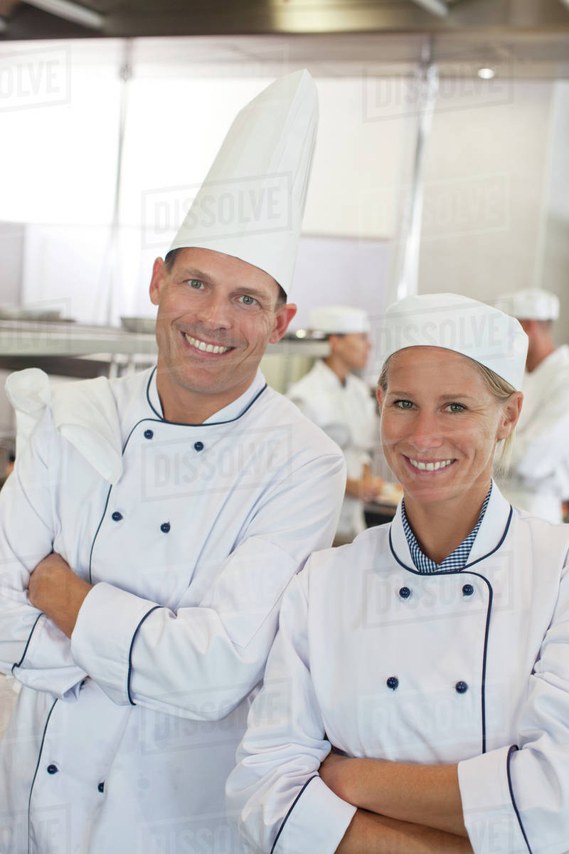 Chefs smiling in restaurant kitchen - Stock Photo - Dissolve