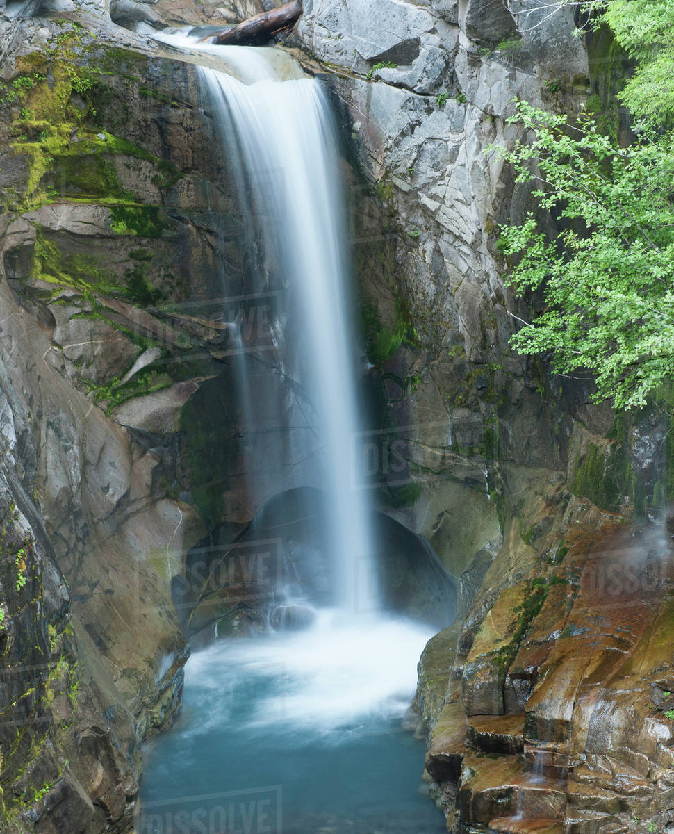 Waterfall emptying into still pool - Royalty-free Stock Photo | Dissolve