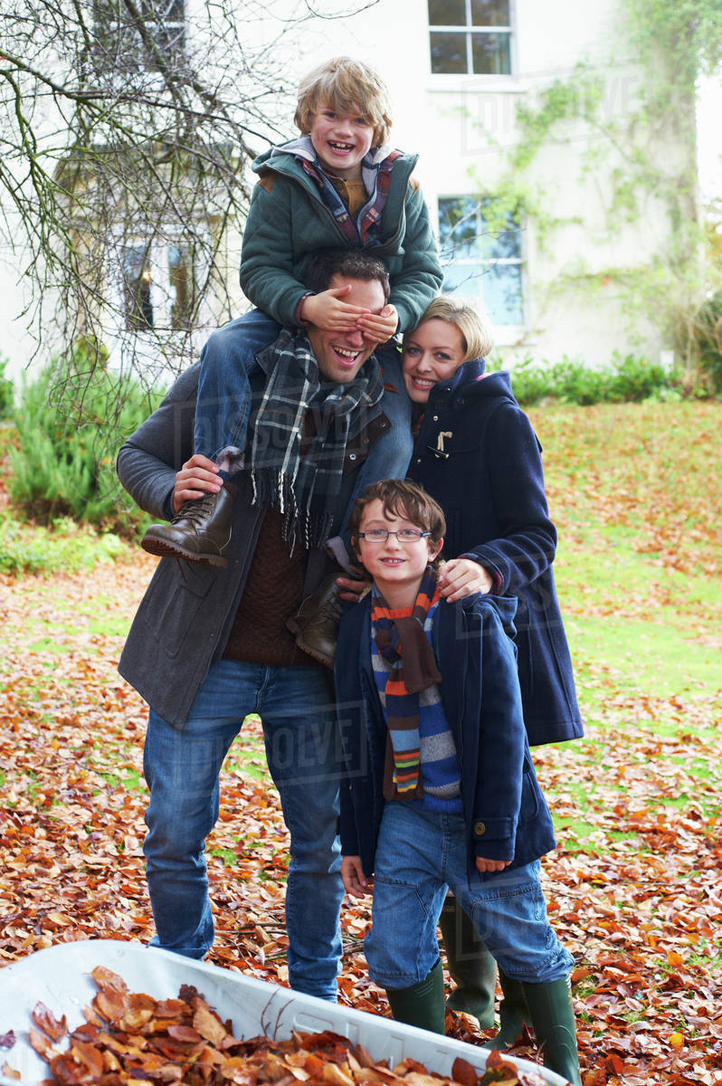 Family smiling together outdoors - Stock Photo - Dissolve