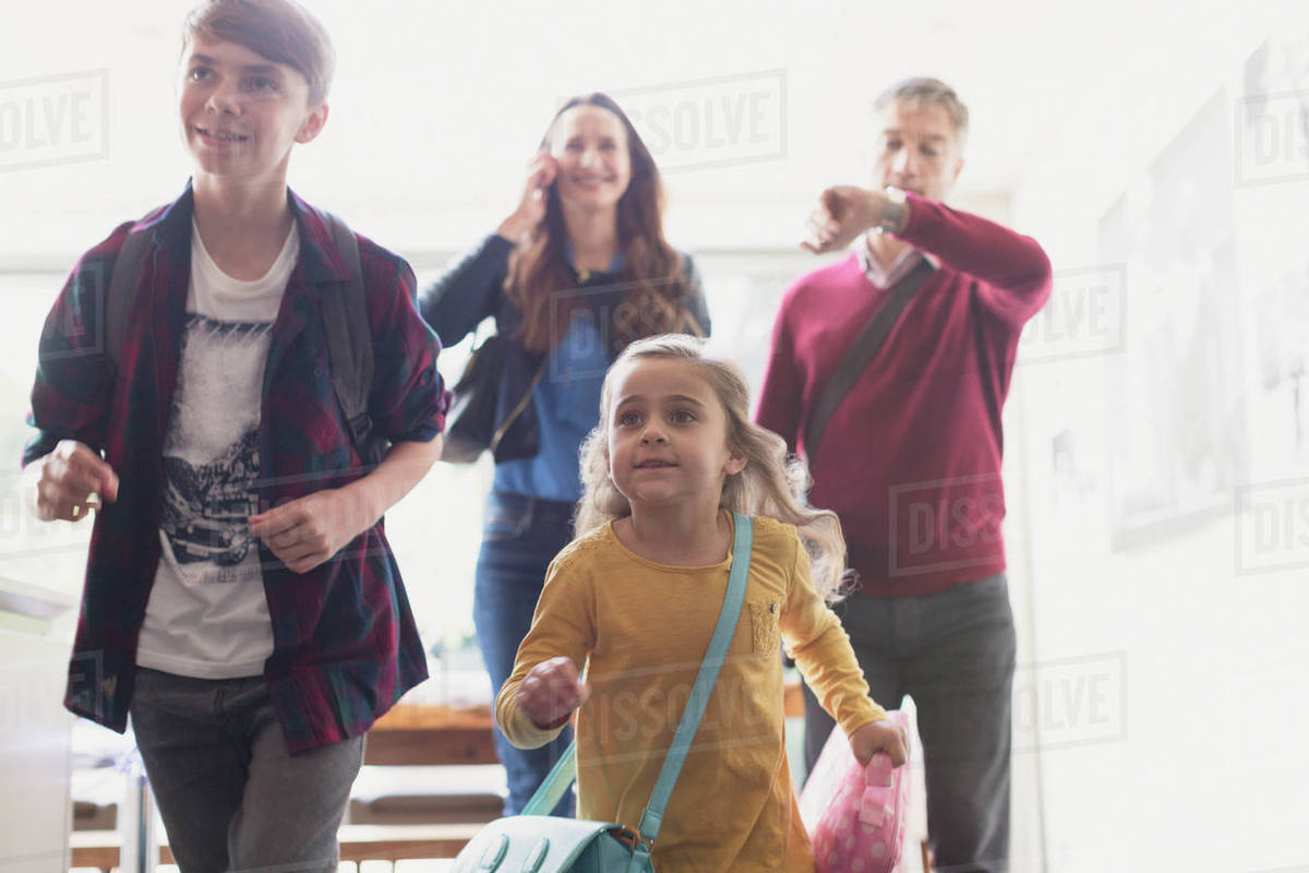 Family rushing to leave house - Royalty-free Stock Photo | Dissolve