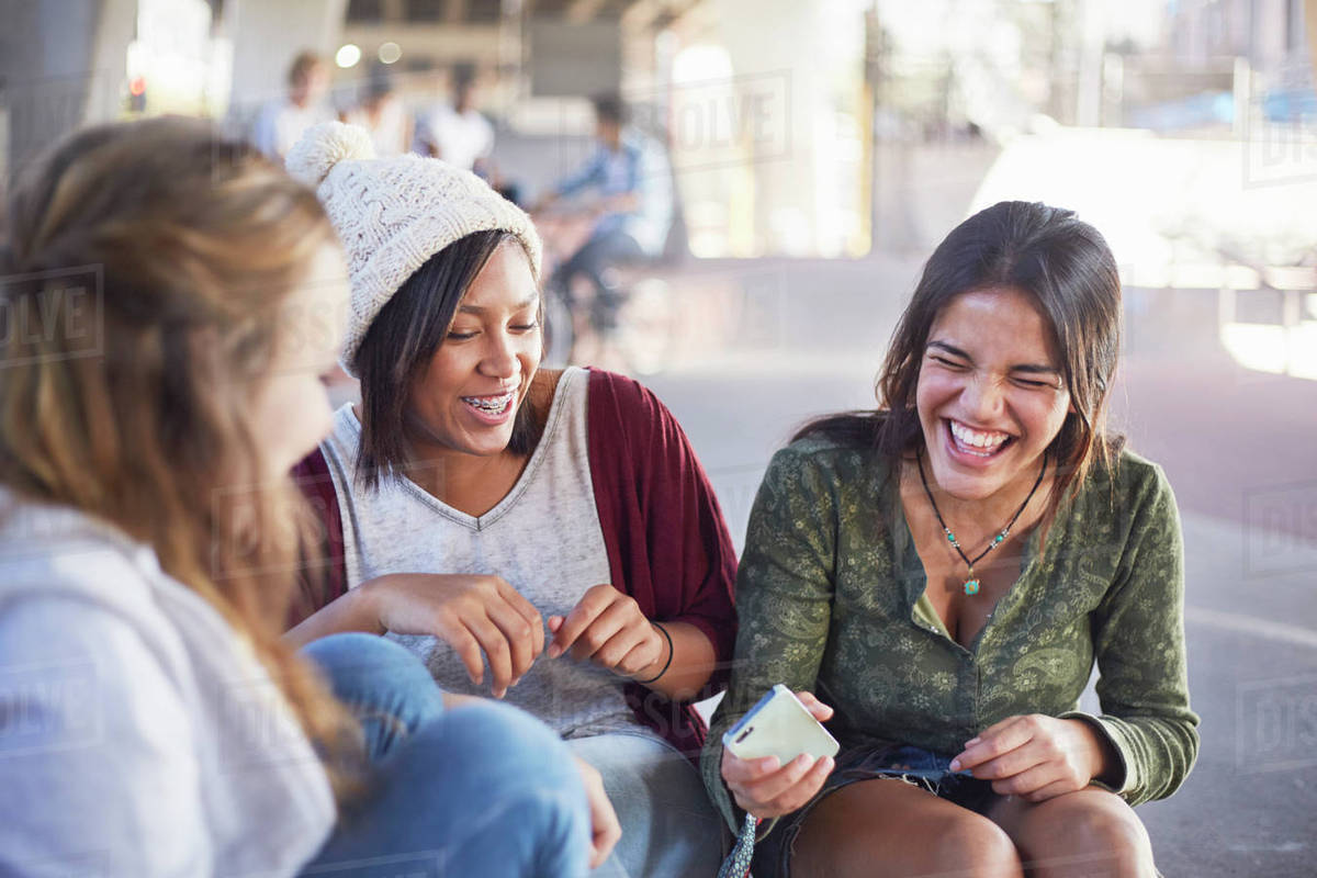 Teenage girls with cell phone laughing and hanging out - Stock Photo ...