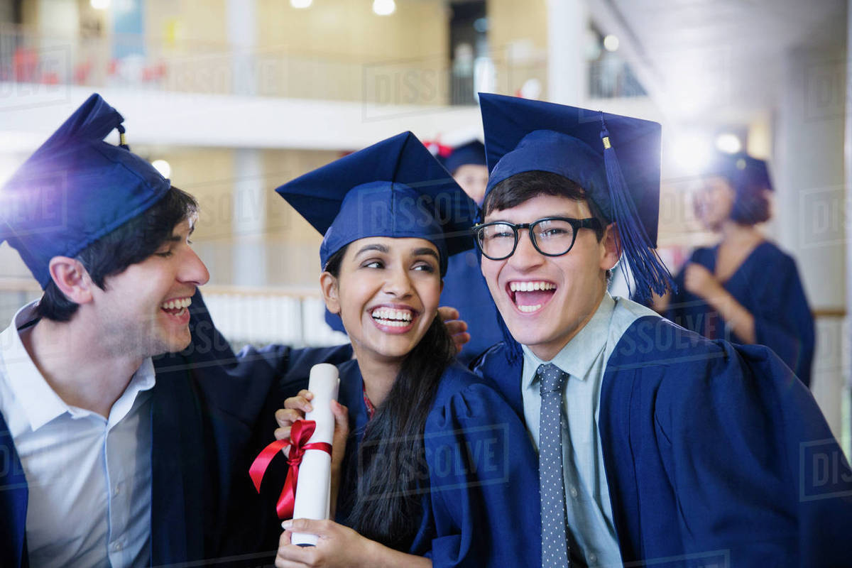 Happy college graduates in cap and gown celebrating with diploma ...