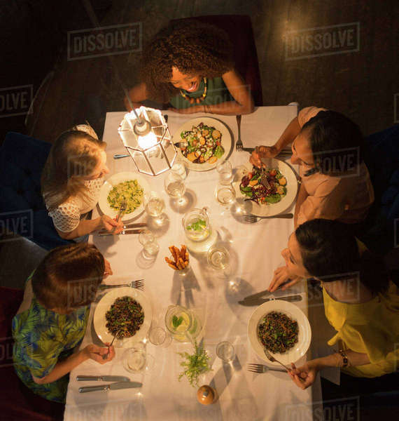 Women friends talking and dining at restaurant table - Royalty-free ...