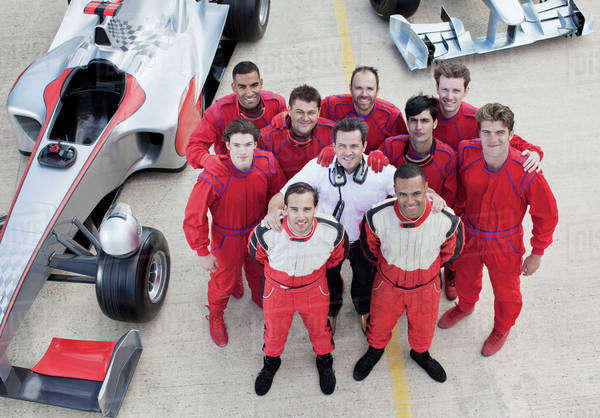 Racing team smiling at pit stop - Royalty-free Stock Photo | Dissolve