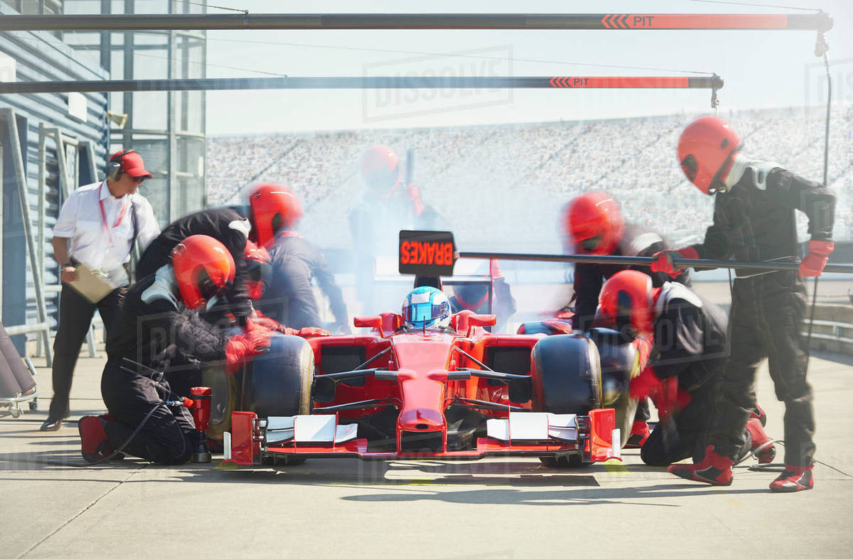 Pit crew working on formula one race car in pit lane - Royalty-free ...