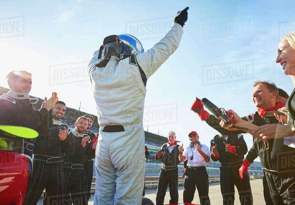 Formula one racing team and driver cheering, celebrating victory on ...