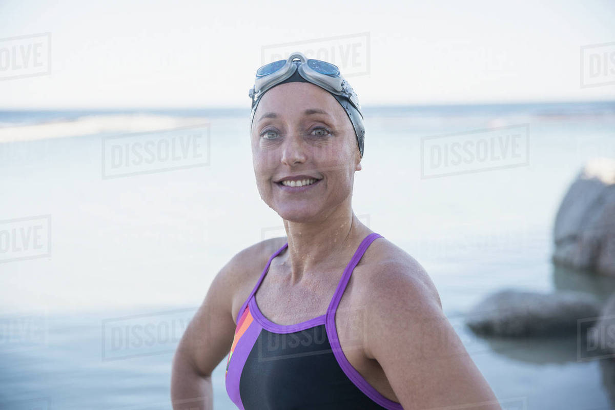Portrait smiling confident female open water swimmer at ocean - Royalty ...