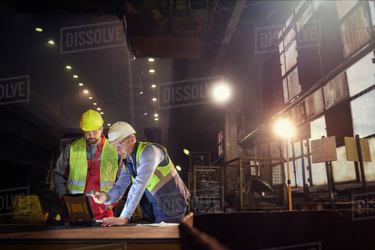 Steelworkers using laptop in steel mill - Royalty-free Stock Photo ...
