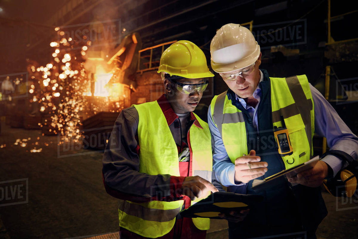 Steelworkers using digital tablets in steel mill - Royalty-free Stock ...
