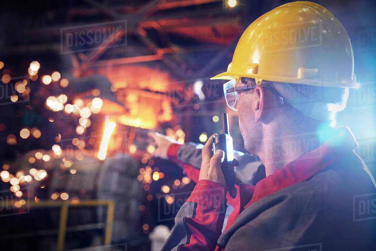 Steelworker talking, using walkie-talkie in steel mill - Royalty-free ...
