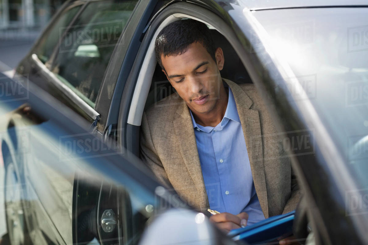 Businessman working in car - Royalty-free Stock Photo | Dissolve