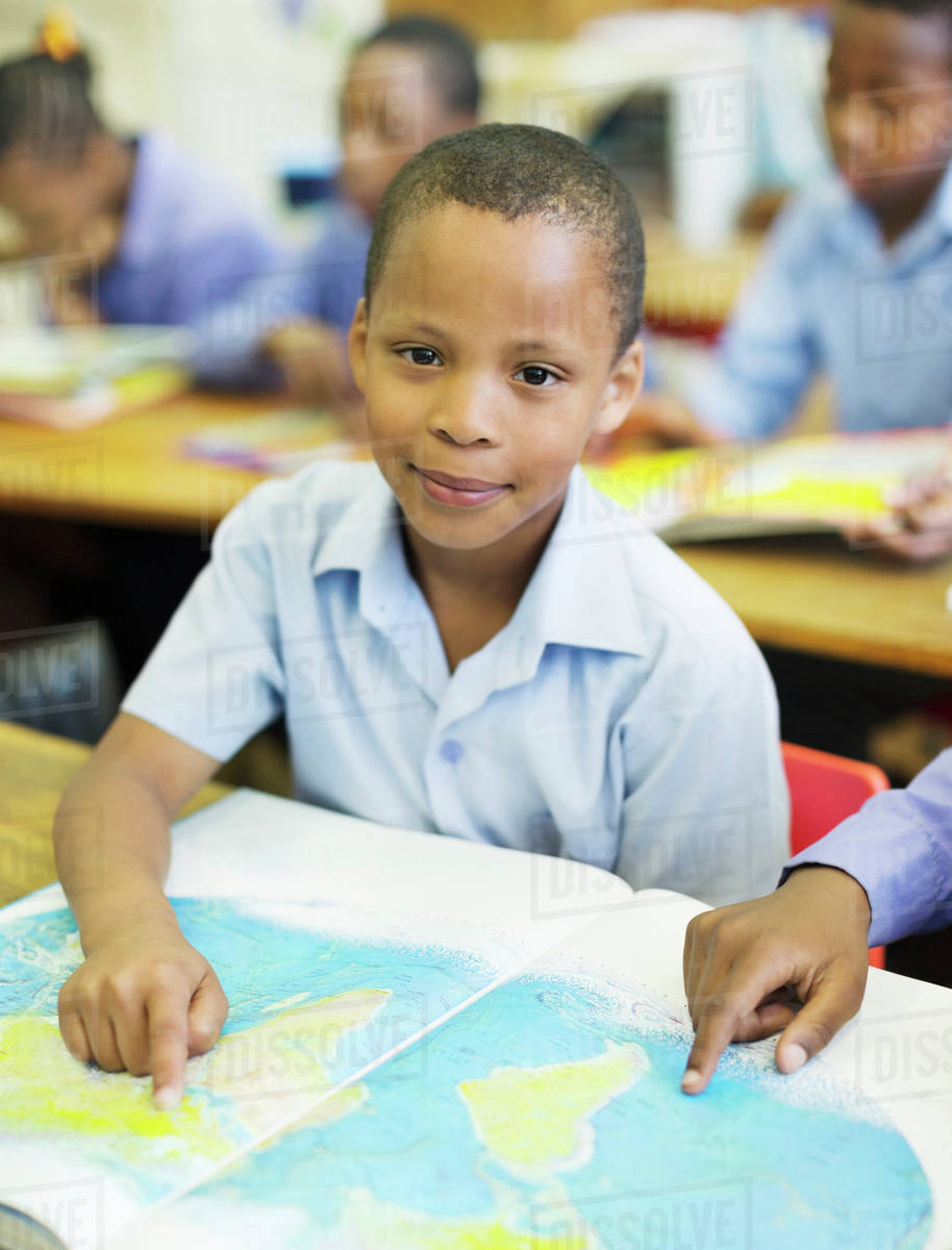 Students using world map in class - Stock Photo - Dissolve