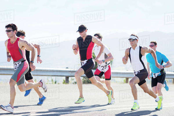 Runners in race on rural road - Royalty-free Stock Photo | Dissolve
