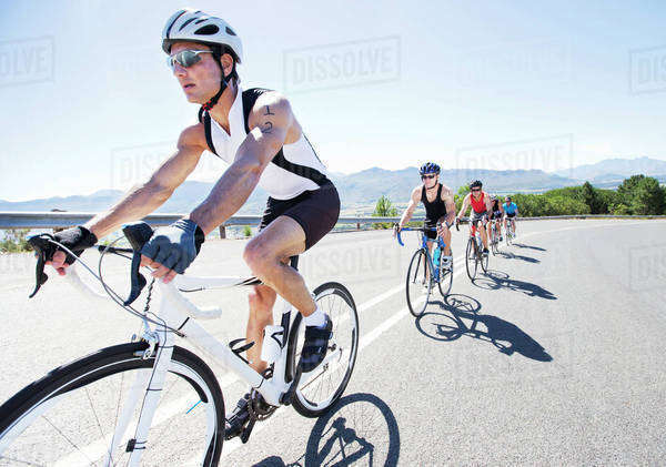 Cyclists in race on rural road - Royalty-free Stock Photo | Dissolve