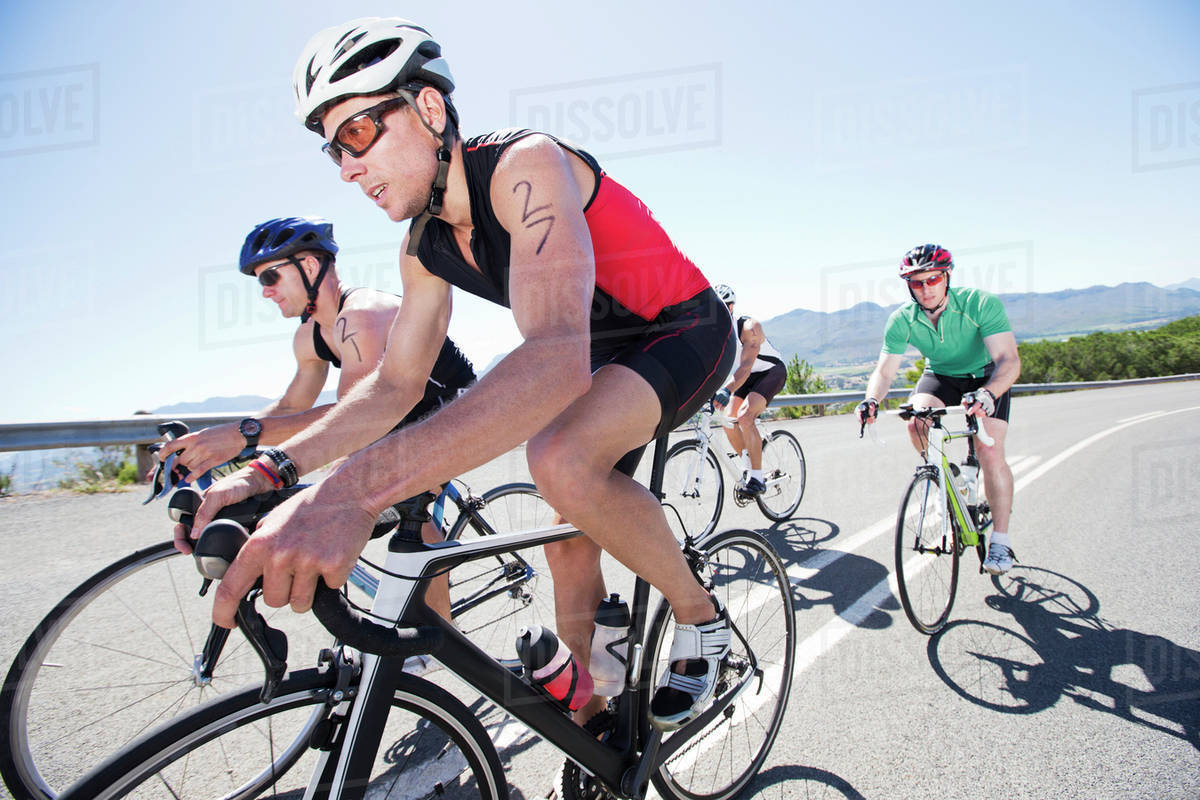 Cyclists in race on rural road - Stock Photo - Dissolve