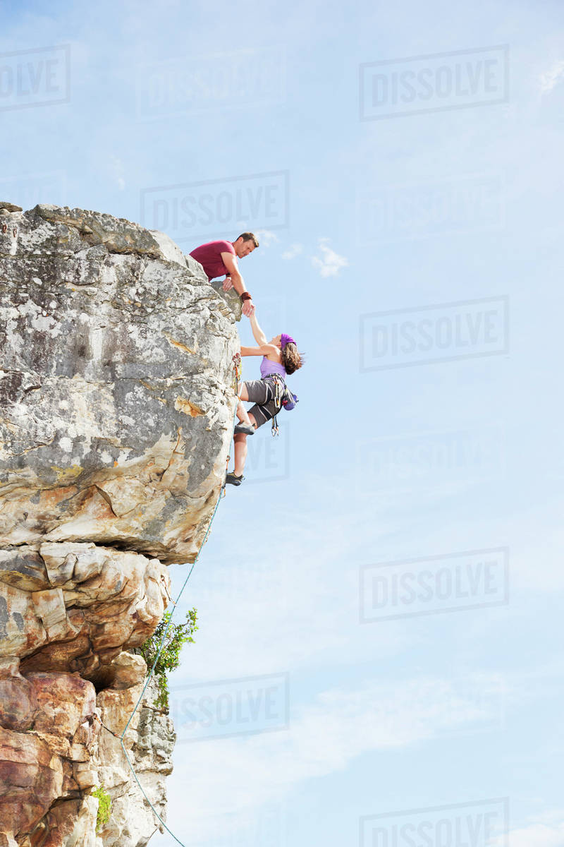 Climbers scaling steep rock face - Royalty-free Stock Photo | Dissolve