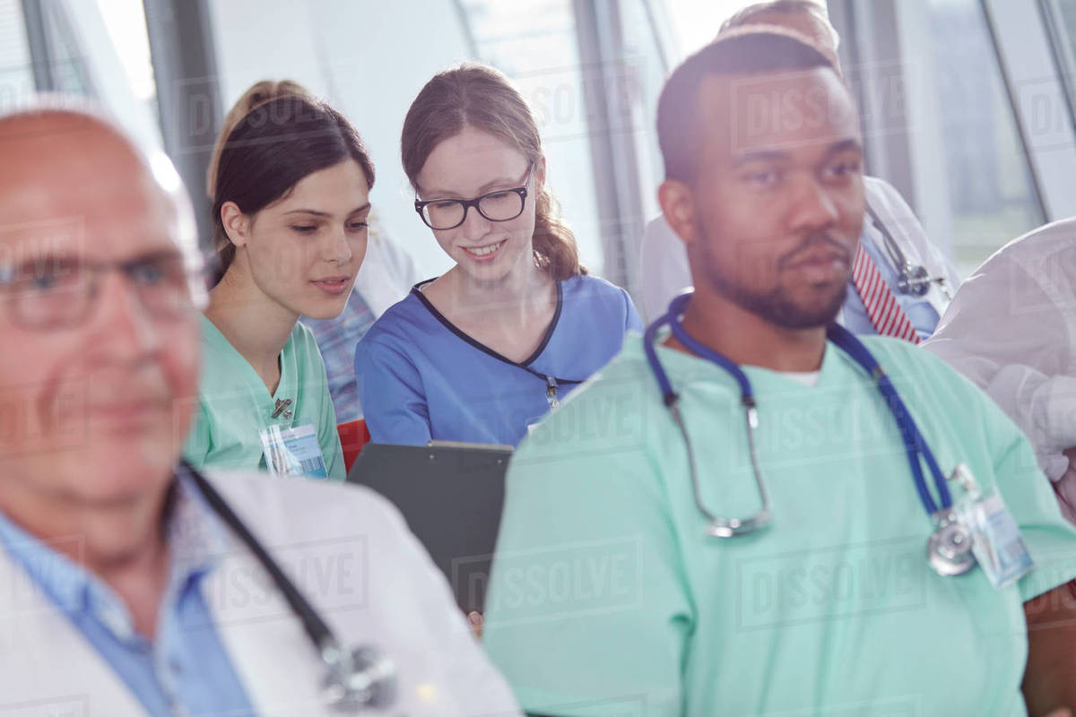 Female nurses talking in conference audience - Royalty-free Stock Photo ...